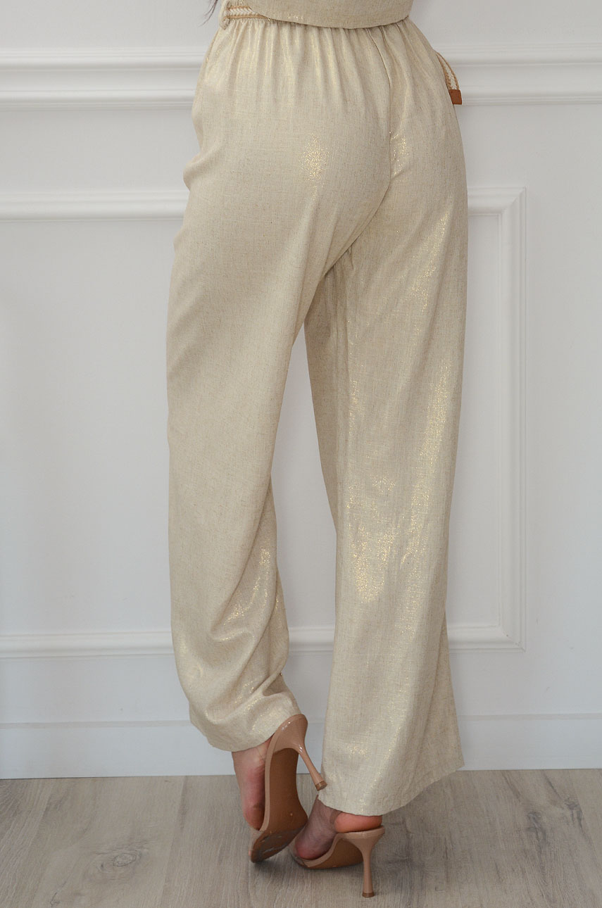 Luźne spodnie z błyszczącą poświatą beżowo-złote. Luźne spodnie z ...
